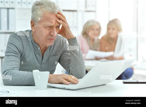 Senior Man Working With Laptop At Modern Office Stock Photo Alamy