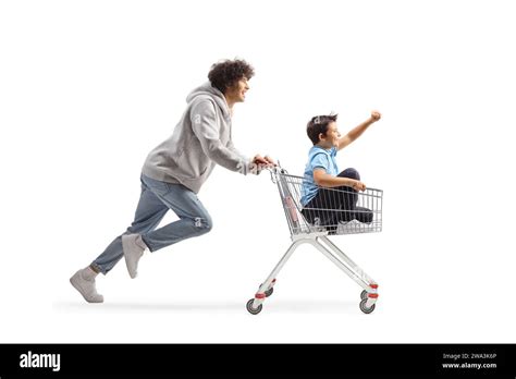 Guy Running And Pushing A Boy Inside A Shopping Cart Isolated On White