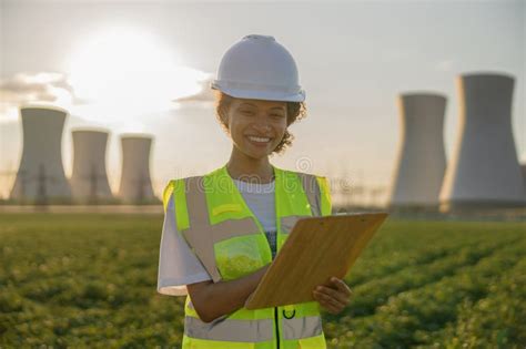 female engineer constructor stands with clipboard on field on