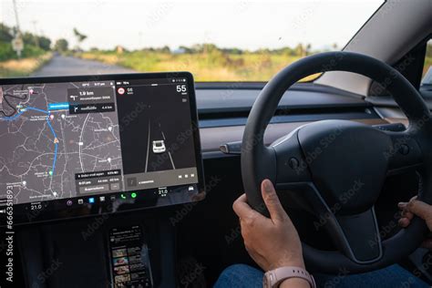 Side View Of Traveller Woman Driver Using Navigator In Car Screen While Driving Modern Car Stock