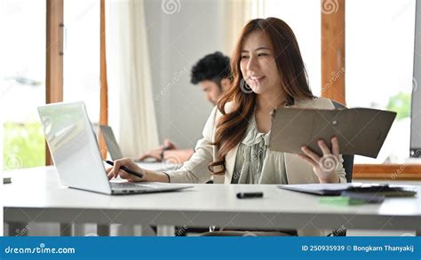Beautiful Asian Female Secretary Working At Her Office Desk Stock Image
