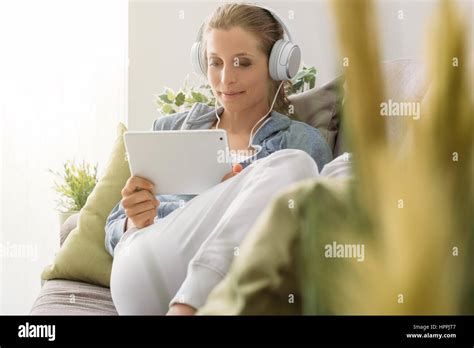Attractive Woman Relaxing At Home In The Living Room She Is Lying Down