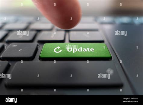 Man Pressing Green Button With Word Update On Modern Black Computer