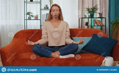 Woman Breathes Deeply With Mudra Gesture Eyes Closed Meditating With