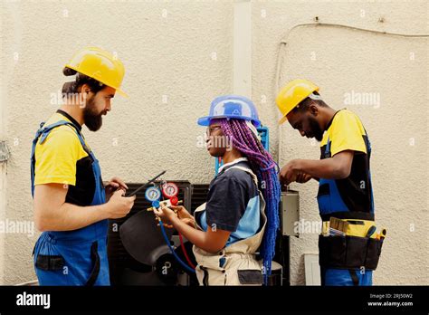 Skilled Technicians Refilling Freon And Fixing Leaks In External Air