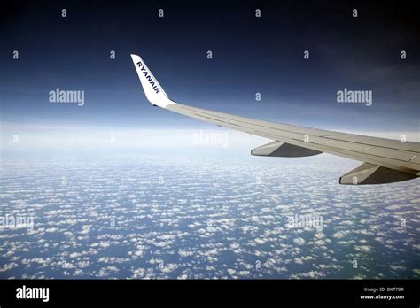 Ryanair Plane Wing Flying Over Clouds And Blue Sky Stock Photo Alamy