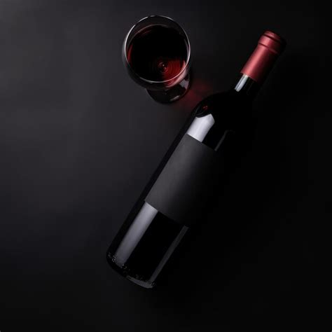 Premium Photo Wine Bottle And Glass With Red Wine On Black Background