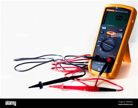 Digital Multimeter With Probes And Green Backlit Display On A White