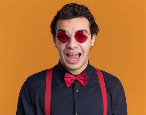 Free Photo Stylish Man With Bow Tie Wearing Glasses And Suspenders