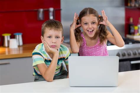 Girl Teasing Her Brother In Kitchen Stock Image Image Of Caucasian