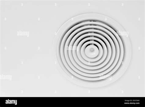Round Ventilation Diffuser Mounted In White Ceiling Close Up Photo