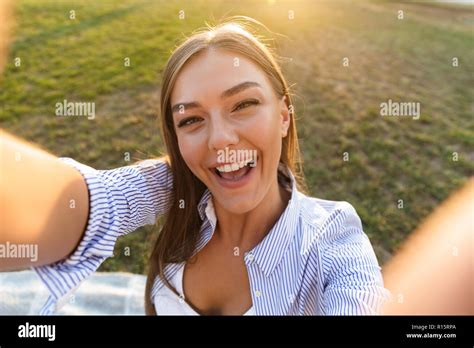 Close Up Of An Excited Young Woman Taking A Selfie At The Park With