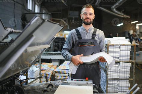 printing house interior with modern offset print machine and operator