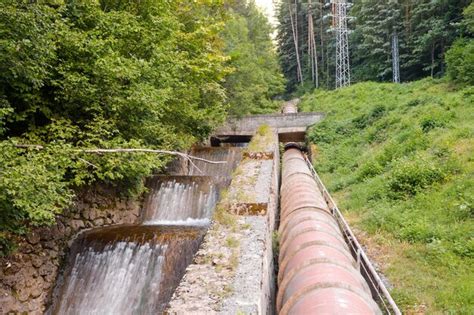 Premium Photo A Water Pipe Running Down A Hill With A Waterfall In