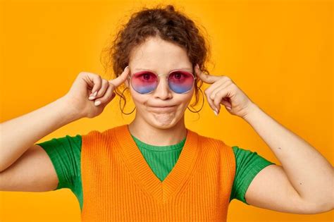 Premium Photo Young Woman Wearing Sunglasses Against Yellow Background