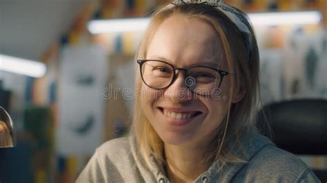Blonde Woman Face Closeup With Black Framed Glasses Looks At Camera And