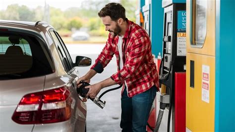 Premium Photo Man Putting Gasoline Fuel Into His Car In A Pump Gas Station