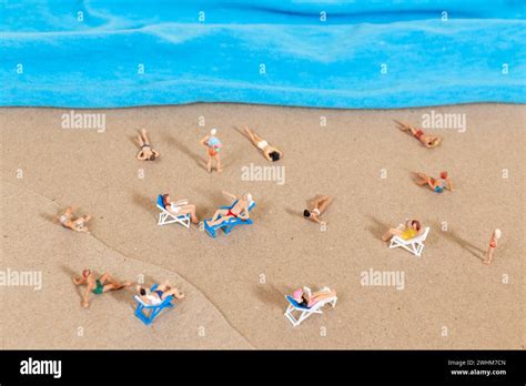 A Tiny Person In A Swimsuit Is Relaxing On The Beach In The Summer Stock Photo Alamy