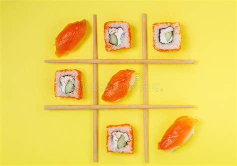 Creative Arrangement Of Sushi And Sashimi On Yellow Background For Japanese Cuisine Concept
