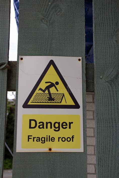 Danger Fragile Roof Sign In Black Letters On A Yellow Background Stock