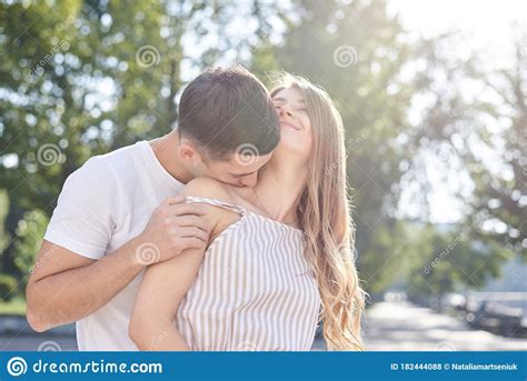 Handsome Brunette Guy Wearing White T Shirt Hugging And Kissing