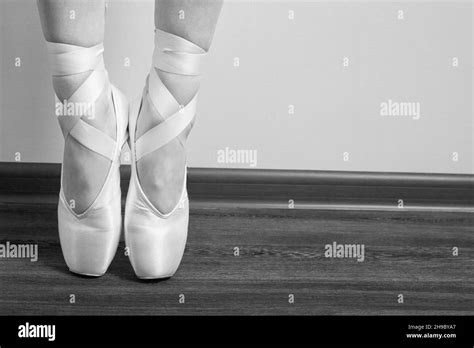 Female Ballerina Feet In Pointes On A Wooden Floor Monochrome Closeup