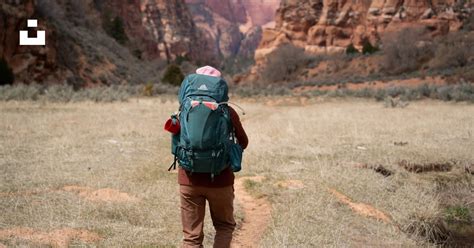 A Person With A Backpack Walking In A Field Photo Free Zion National