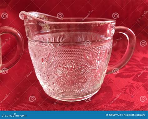 Vintage Pressed Glass Clear Crystal Cream Pitcher On Red Background
