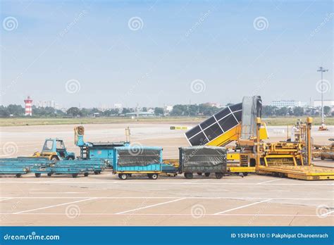 Air Plane In Airport Terminal Loading Passengers And Cargo Luggage