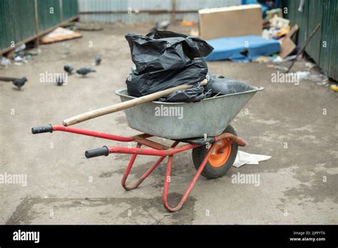 Garden Cart With Black Bags Inside Cleaning Of Territory