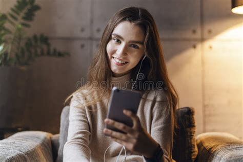 Pretty Millennial Woman Listening To Music Wearing Wireless Headphones