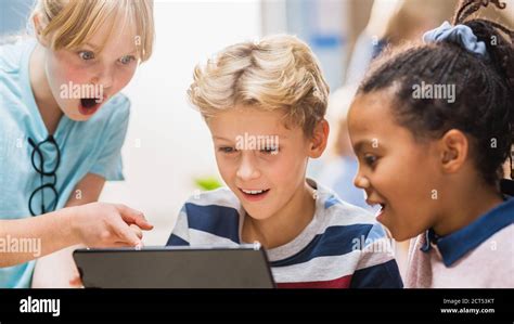 Elementary School Computer Science Class Two Girls And Boy Use Digital