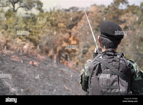 Soldier Is Using Radio For Communication During Military Operation In