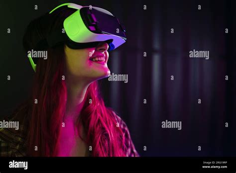 Happy Young Woman Exploring A Virtual World With Her Vr Headset She