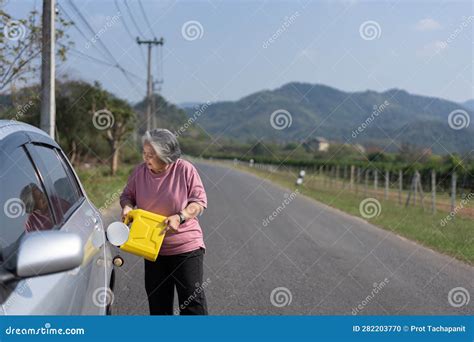 The Car Ran Out Of Gas And Stalled Beside The Road In Suburbs And An Elderly Asian Woman Used A