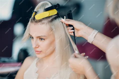 Premium Photo Hairdresser Female Making Hair Extensions To Young