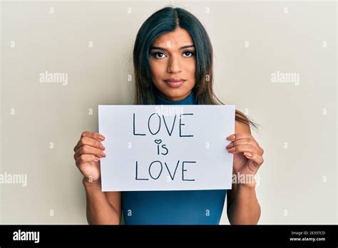 Young Latin Transsexual Transgender Woman Holding Paper With Love Is