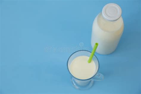 Bottle Of Organic Milk And Glass Of Milk On The Blue Background With