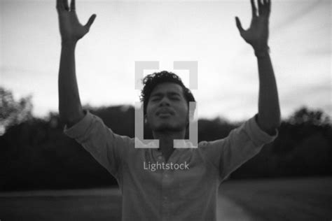 Man With Arms Raised In Praise To God — Photo — Lightstock