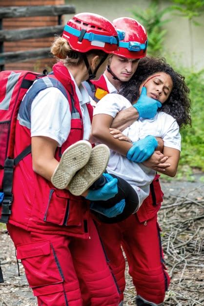Premium Photo Rescue Workers Carrying Injured Woman During Tornado