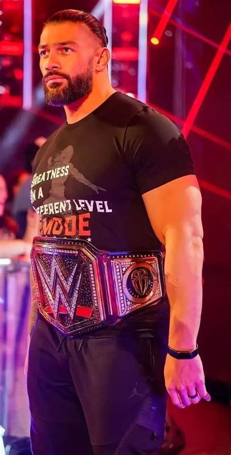 A Man With A Beard Wearing A Wrestling Belt