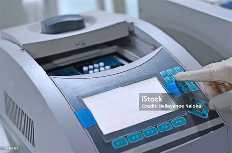 นักวิทยาศาสตร์ถือหลอด Pcr ใส่ลงในเครื่อง Pcr ภาพสต็อก ดาวน์โหลดรูปภาพ
