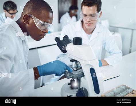 Science Laboratory And Team Doing Research With Microscope For Medical Discovery Analytics And