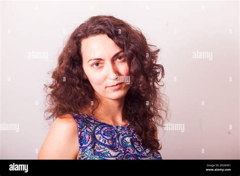 Portrait Of Attractive Middle Aged Woman With Curly Hair Stock Photo