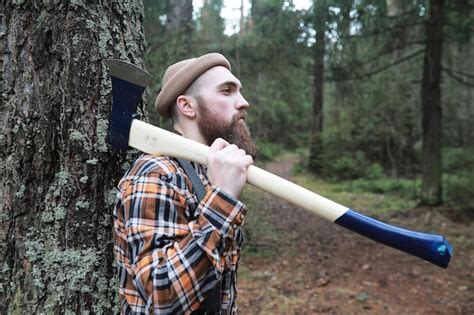 Premium Photo A Bearded Lumberjack With A Large Ax
