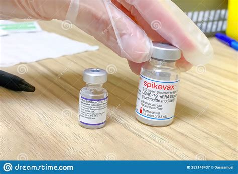 A Healthcare Worker Holding A Pfizer And A Moderna Vial Covid 19 Vials