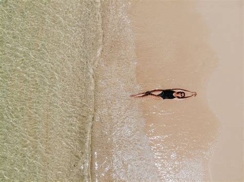 Aerial View Of Young Woman In Black Bikini Lying On Beach With White