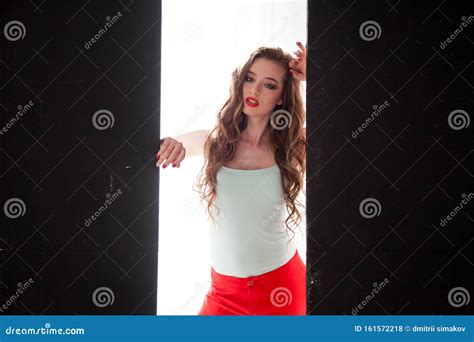Portrait Of A Beautiful Woman With Long Hair Sitting On The Floor Stock