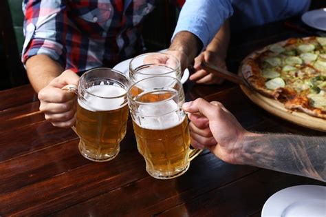 Premium Photo Male Hands Holding Glasses With Beer