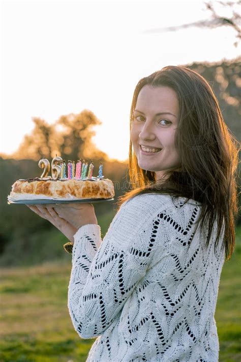 Natural Young Woman In White Sweater Holding A Birthday Cake Of Her